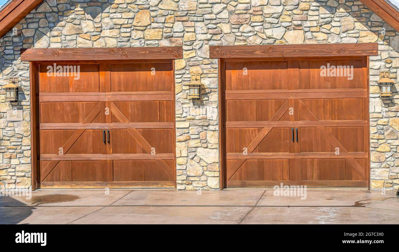 Pano Home garage in Park city with wood doors against stone wall under ...