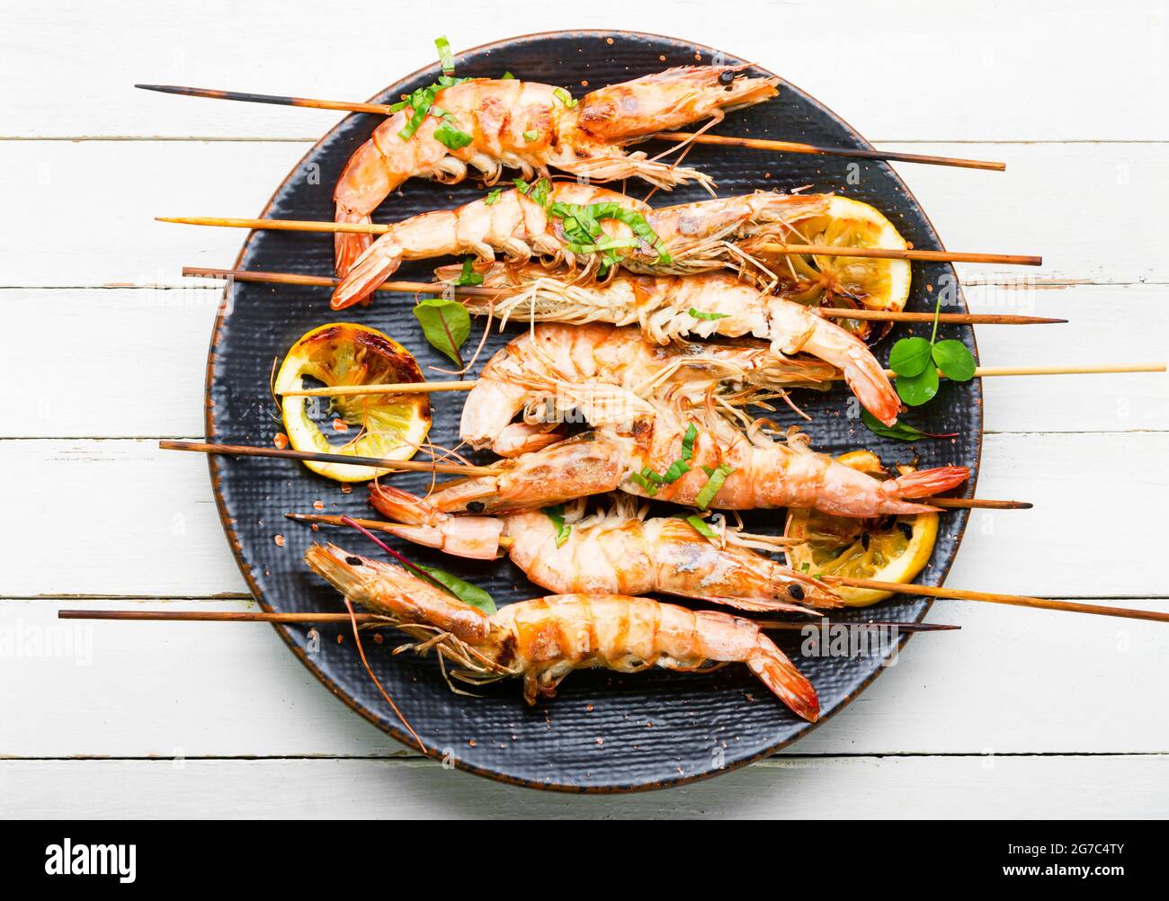 Grilled langoustines,prawn roasted on a skewer.Grilled seafood plate ...