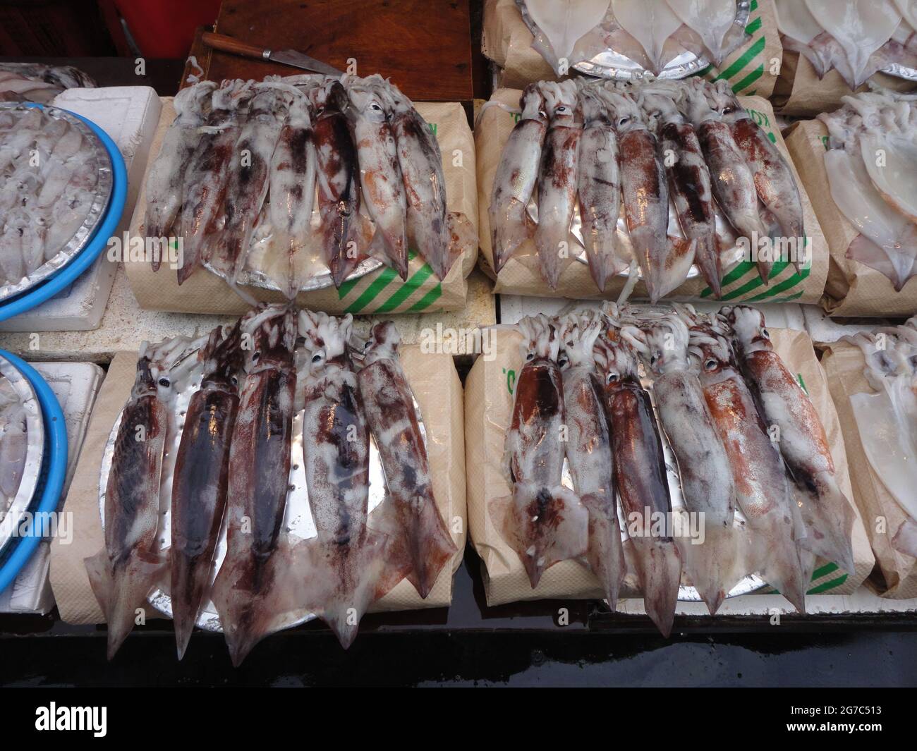 Stack of many fresh squid or cuttlefish at market Stock Photo - Alamy