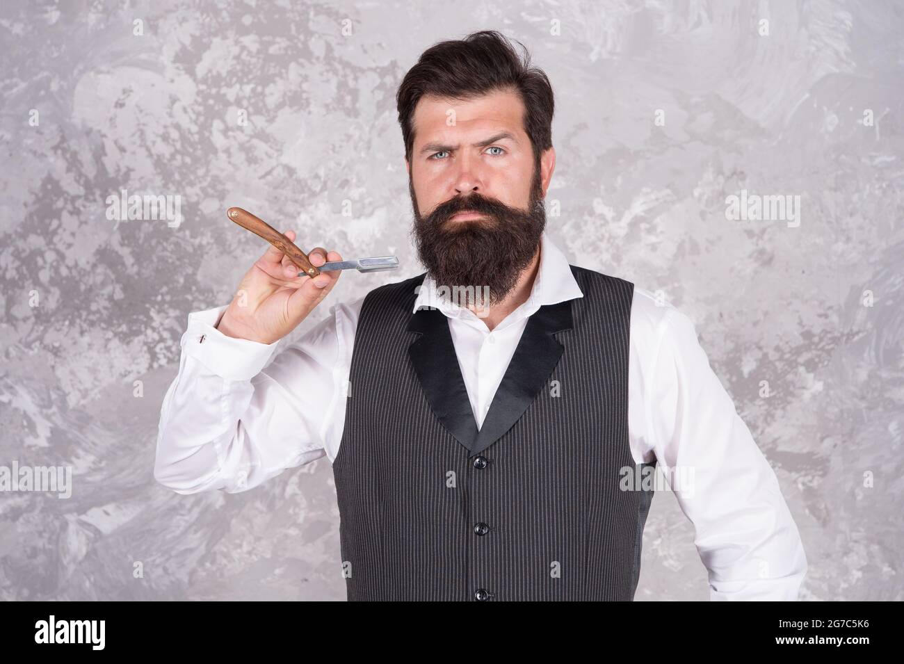 Enjoying morning routine. Master cuts hair and beard in barbershop ...