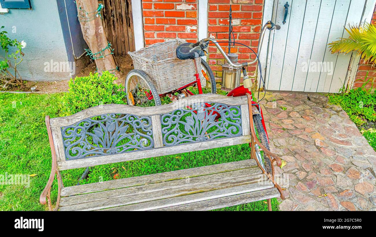 Pano Old wooden bench and bicycle at the front lawn of home in Long ...