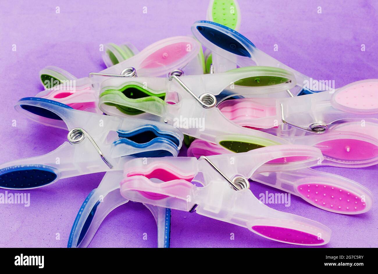 Washing pegs on purple background with copy space Stock Photo - Alamy