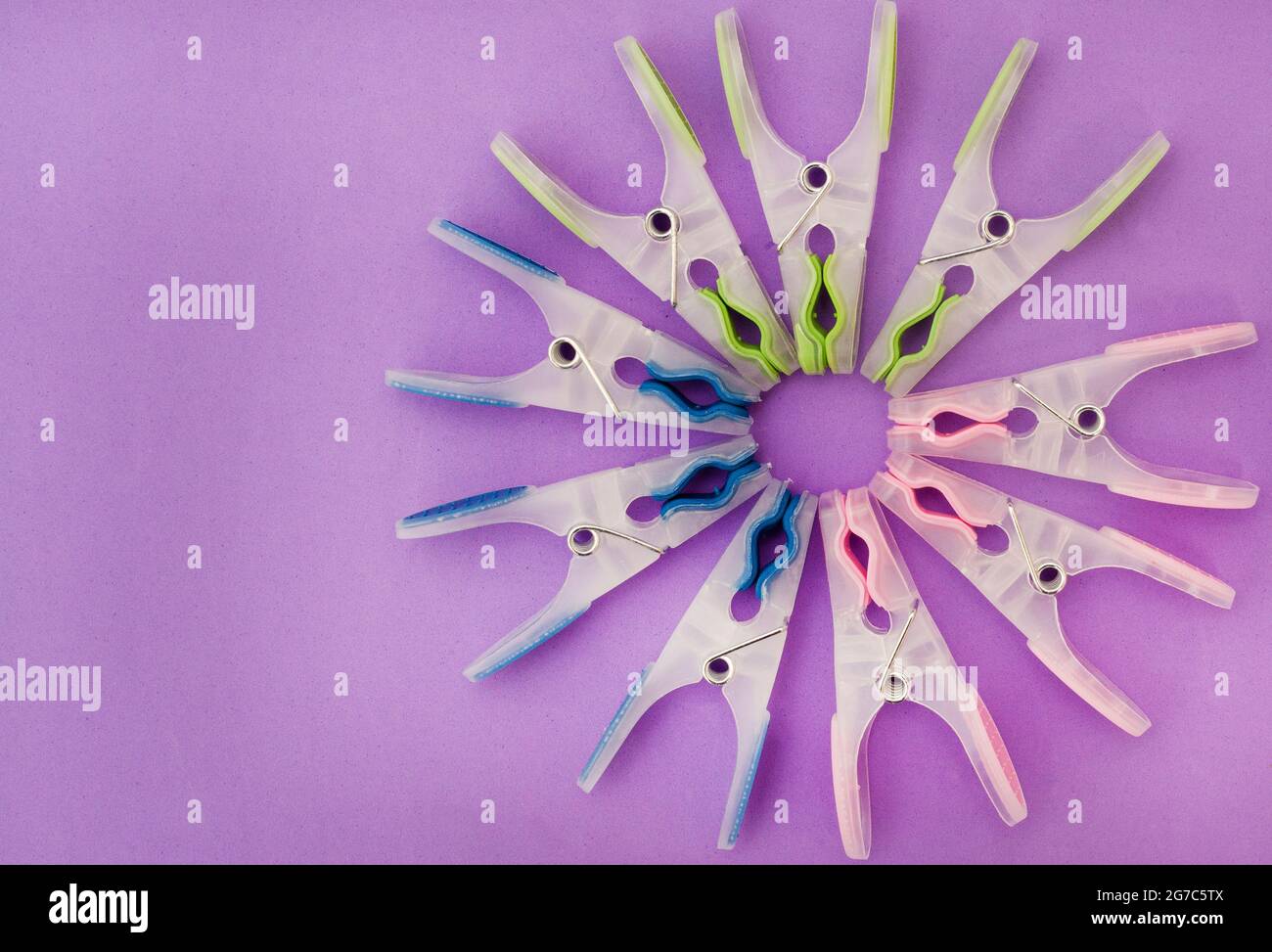 Washing pegs on purple background with copy space Stock Photo - Alamy