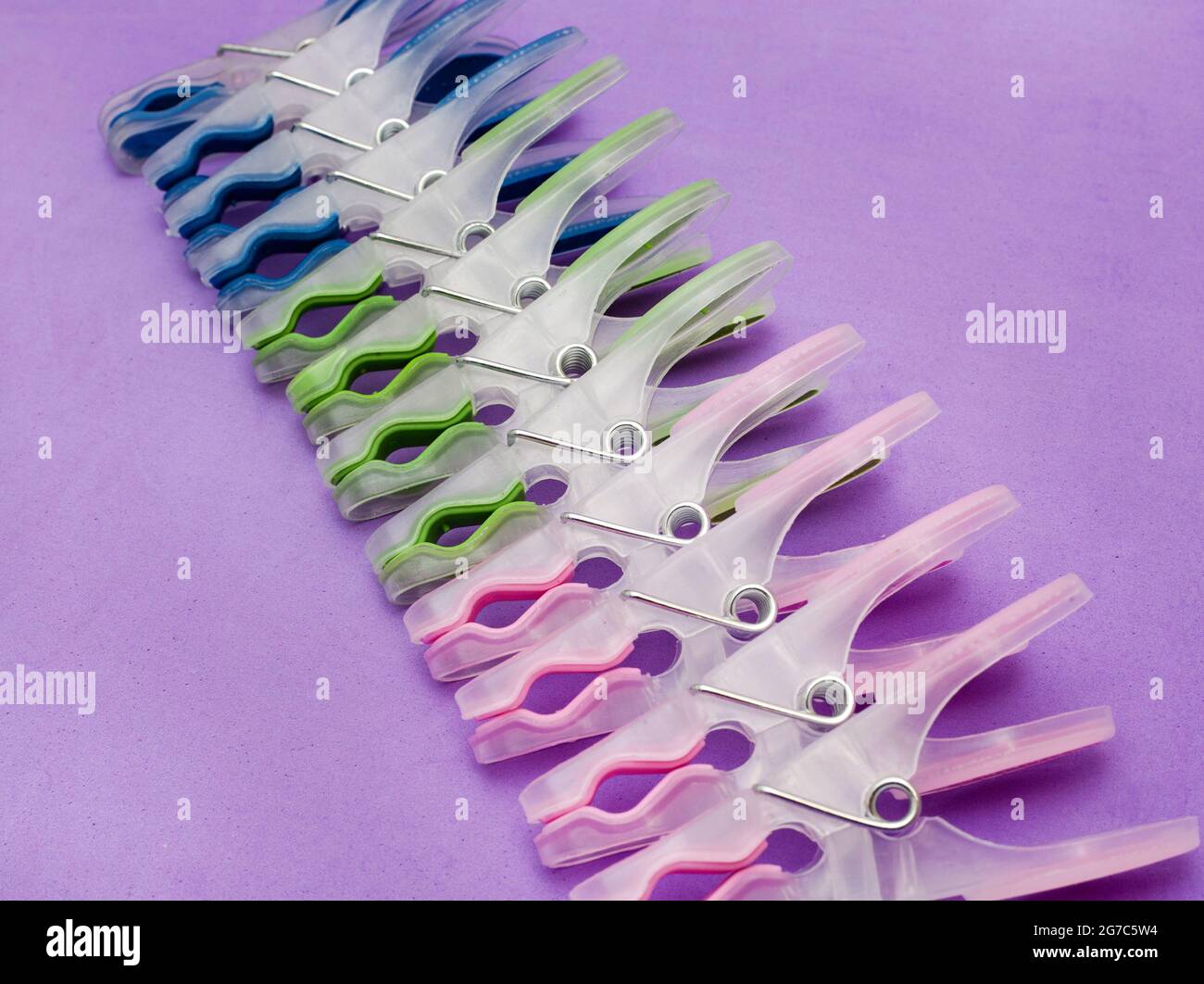 Washing pegs on purple background with copy space Stock Photo - Alamy