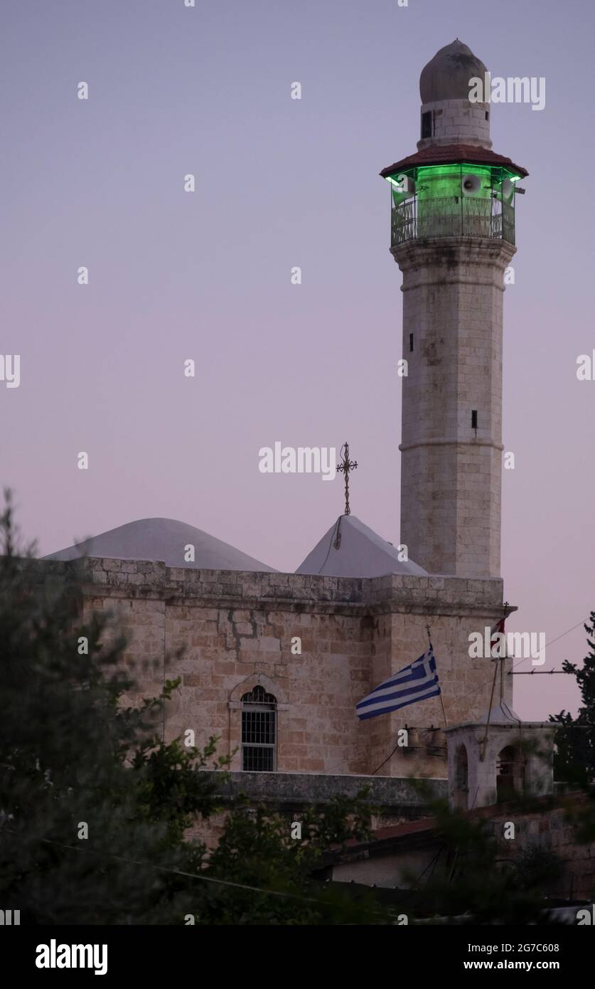 Side view of Church of St. George and minaret of al-Omari Mosque in the ...