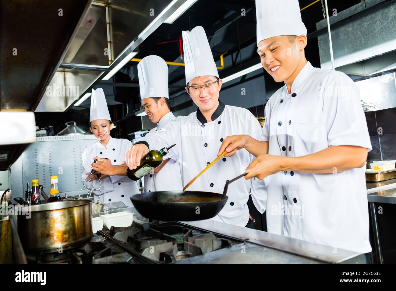 Asian Chefs in restaurant kitchen cooking Stock Photo - Alamy