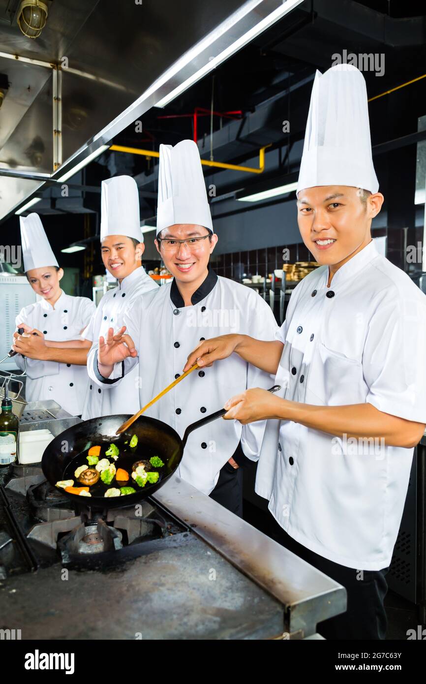 Asian Chefs in restaurant kitchen cooking Stock Photo - Alamy