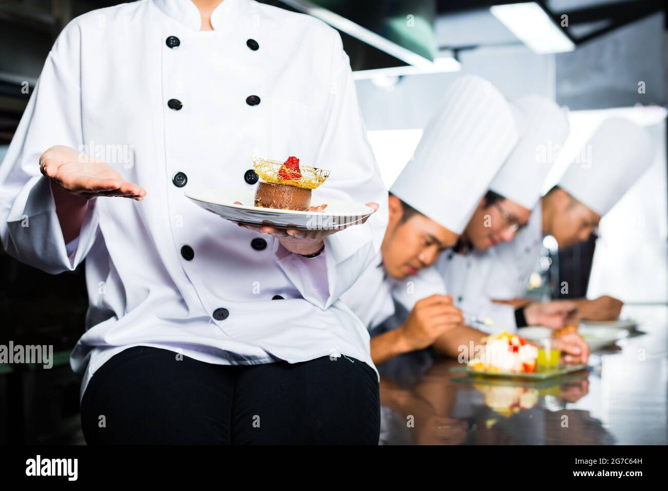 Group of cooks in the kitchen hi-res stock photography and images - Alamy