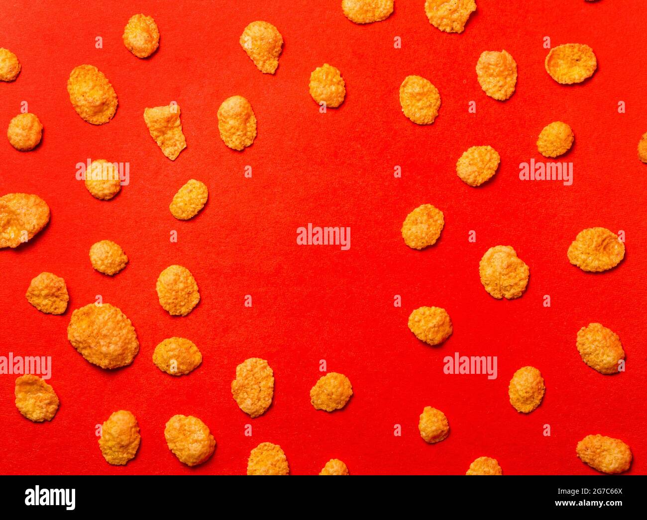 corn flakes on a red background top view Stock Photo - Alamy