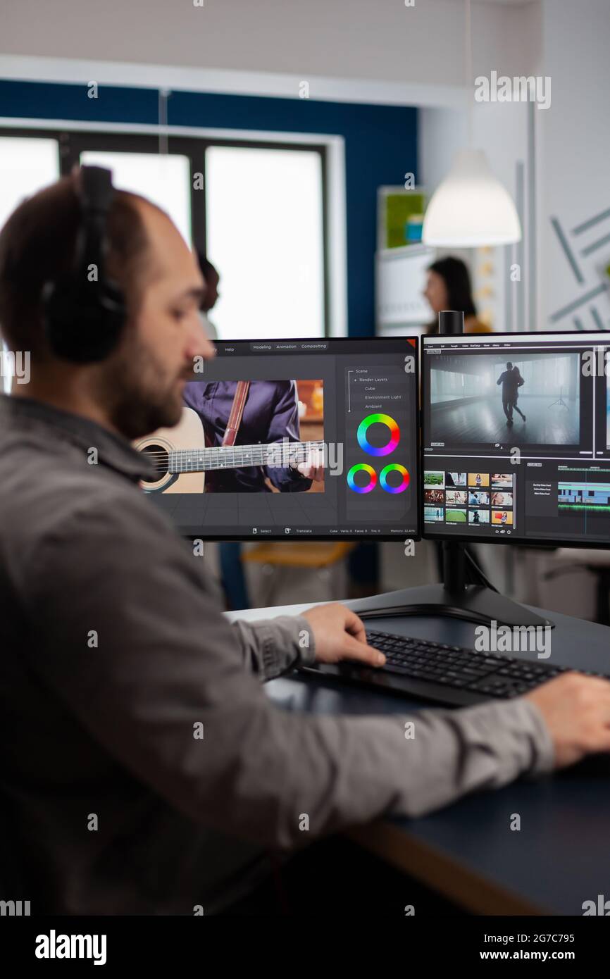 Graphic video production working on pc with two displays editing video ...