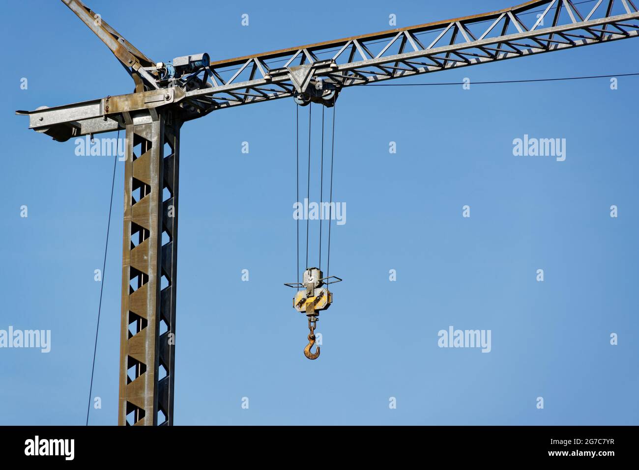 gray construction crane with big pick to lift and move elements in ...