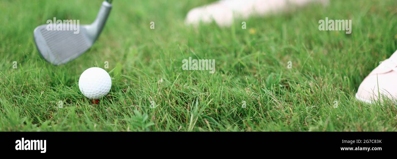 Legs of golfer iron putter and ball on grass Stock Photo - Alamy