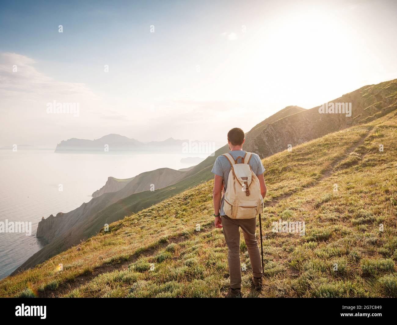 Young man travels alone walking on trail and enjoying on view of ...
