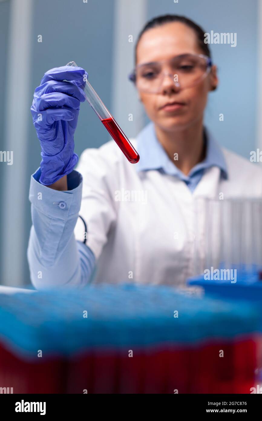 Medical professional looking at test tubes hi-res stock photography and ...