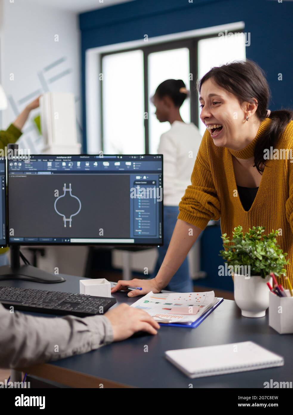 Excited mechanical engineers laughing and discussing about ...