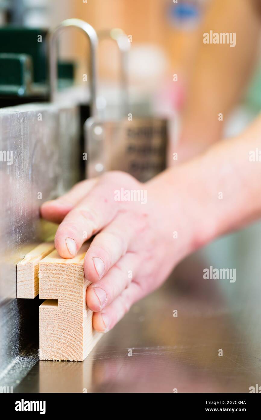 Carpenter working on an electric buzz saw or wood milling and cutting ...