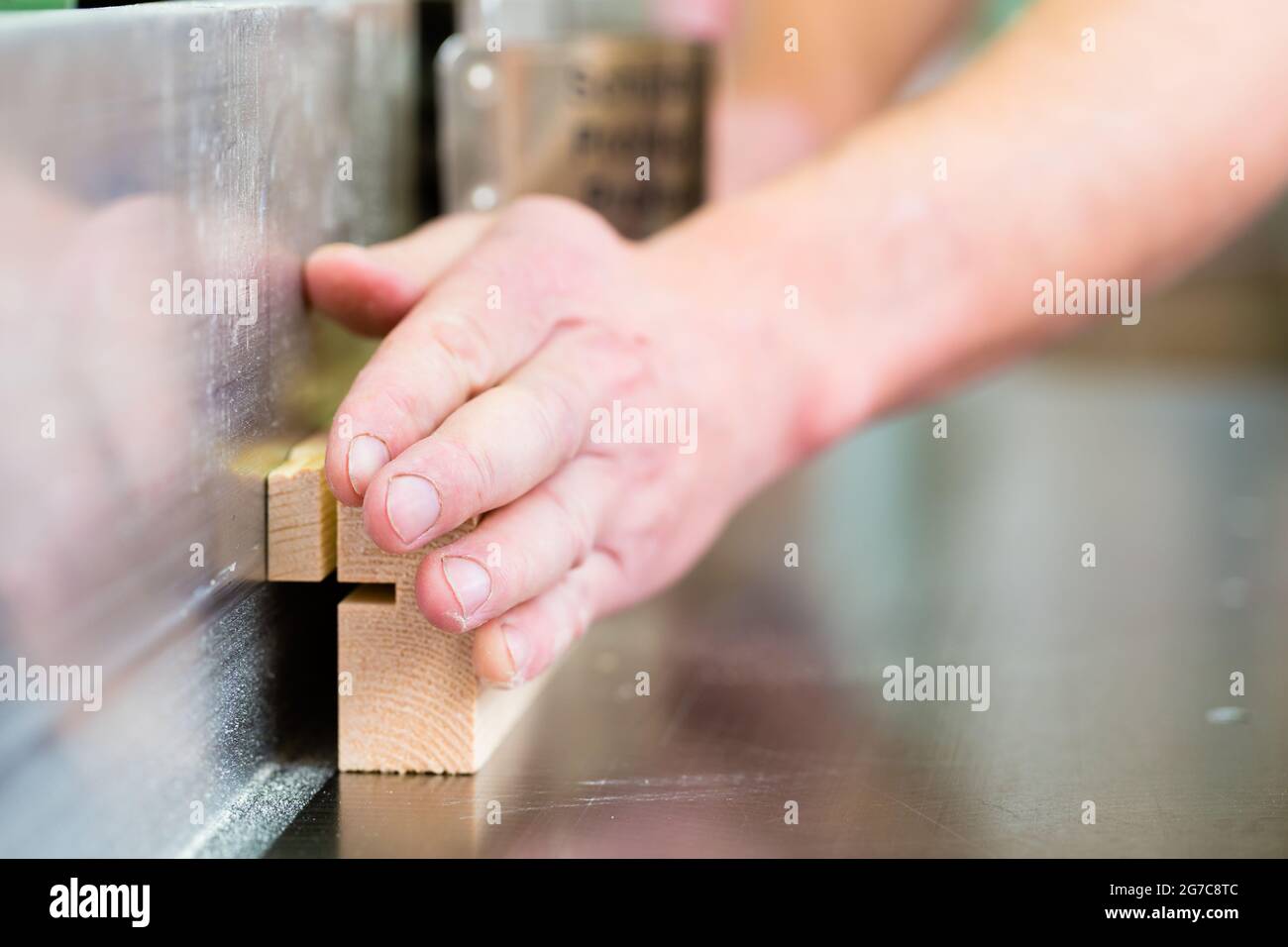 Carpenter working on an electric buzz saw or wood milling and cutting ...