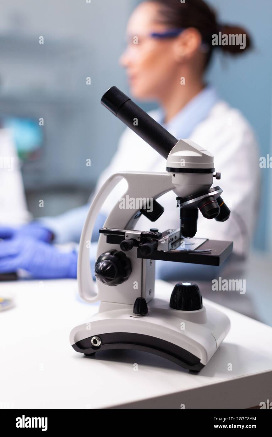 Microbiologist working on microscope in hi-res stock photography and ...