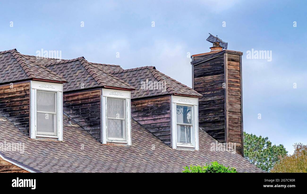Pano Dormer windows on gray roof of house with chimney in San Diego ...