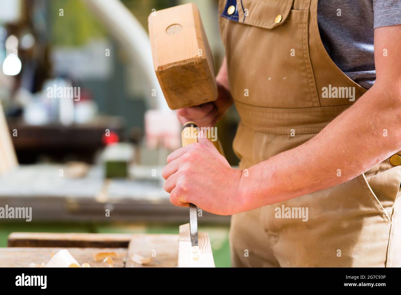 Carpenter with chisel and hammer Stock Photo - Alamy