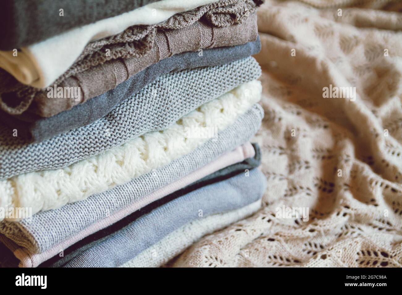 A stack of cozy warm winter clothes lies on the bed Stock Photo - Alamy