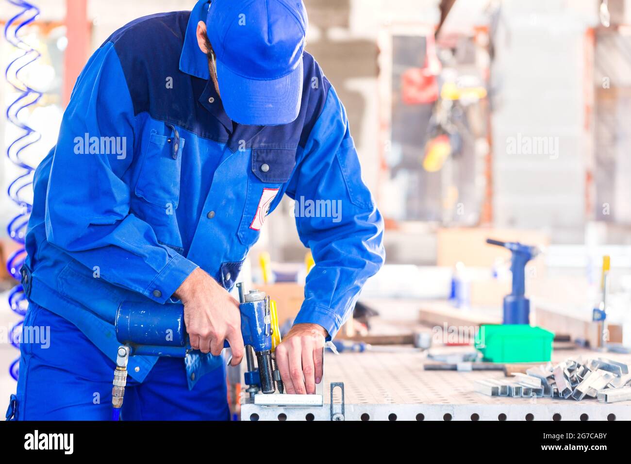 Craftsman rivet metal with air compressed pistol in workshop Stock ...