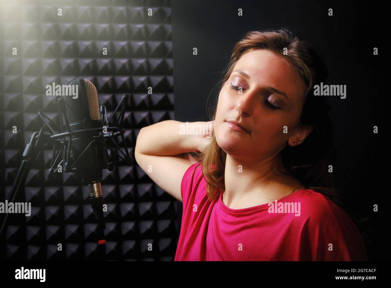 Professional female vocalists in red clothes. Recording a song at the ...