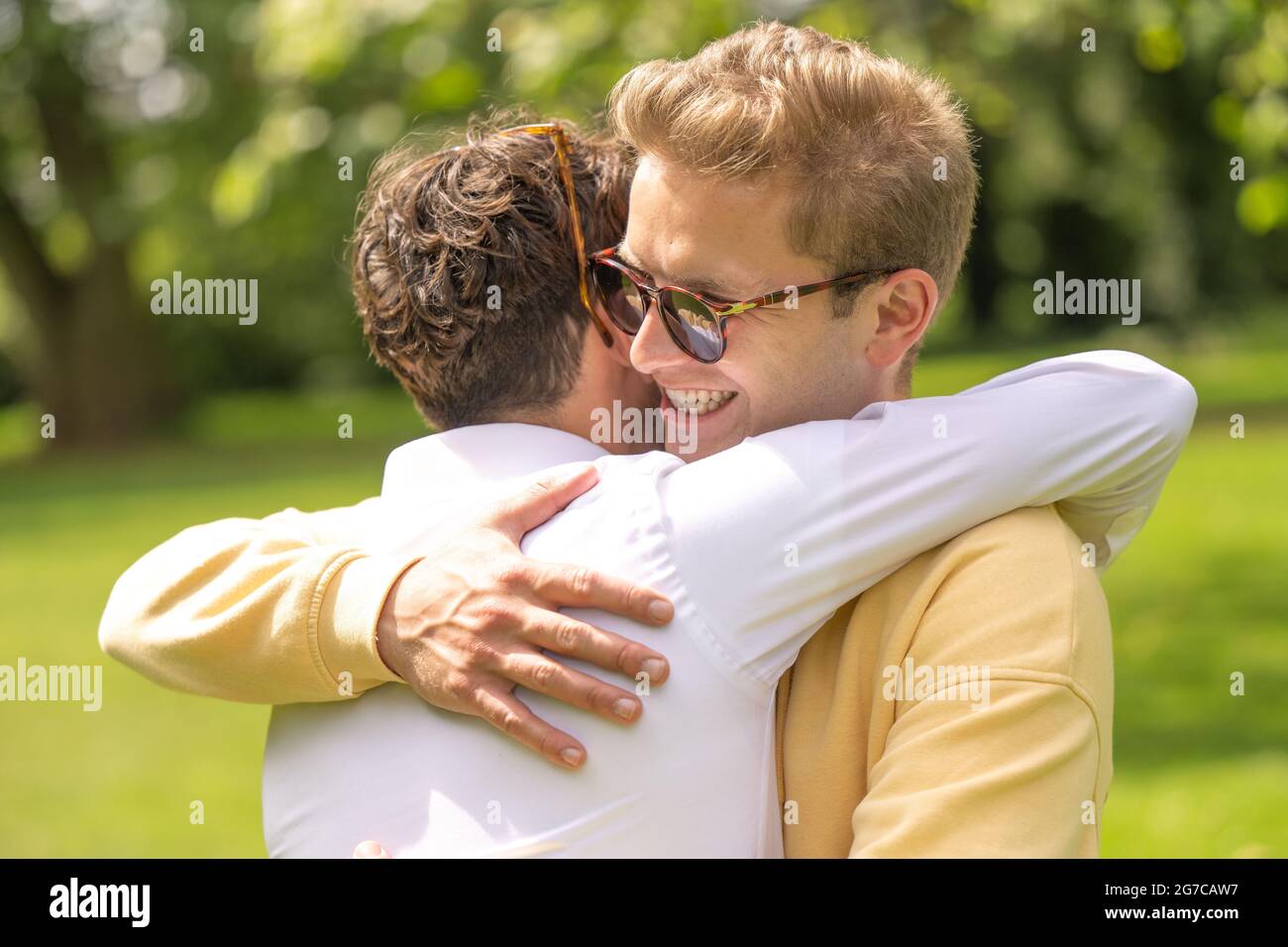 Oldenburg, Germany. 03rd July, 2021. ILLUSTRATION - Two men embrace in ...
