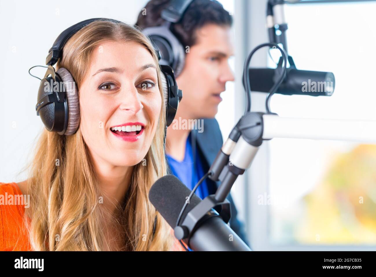 Presenters or moderators - man and woman - in radio station hosting ...