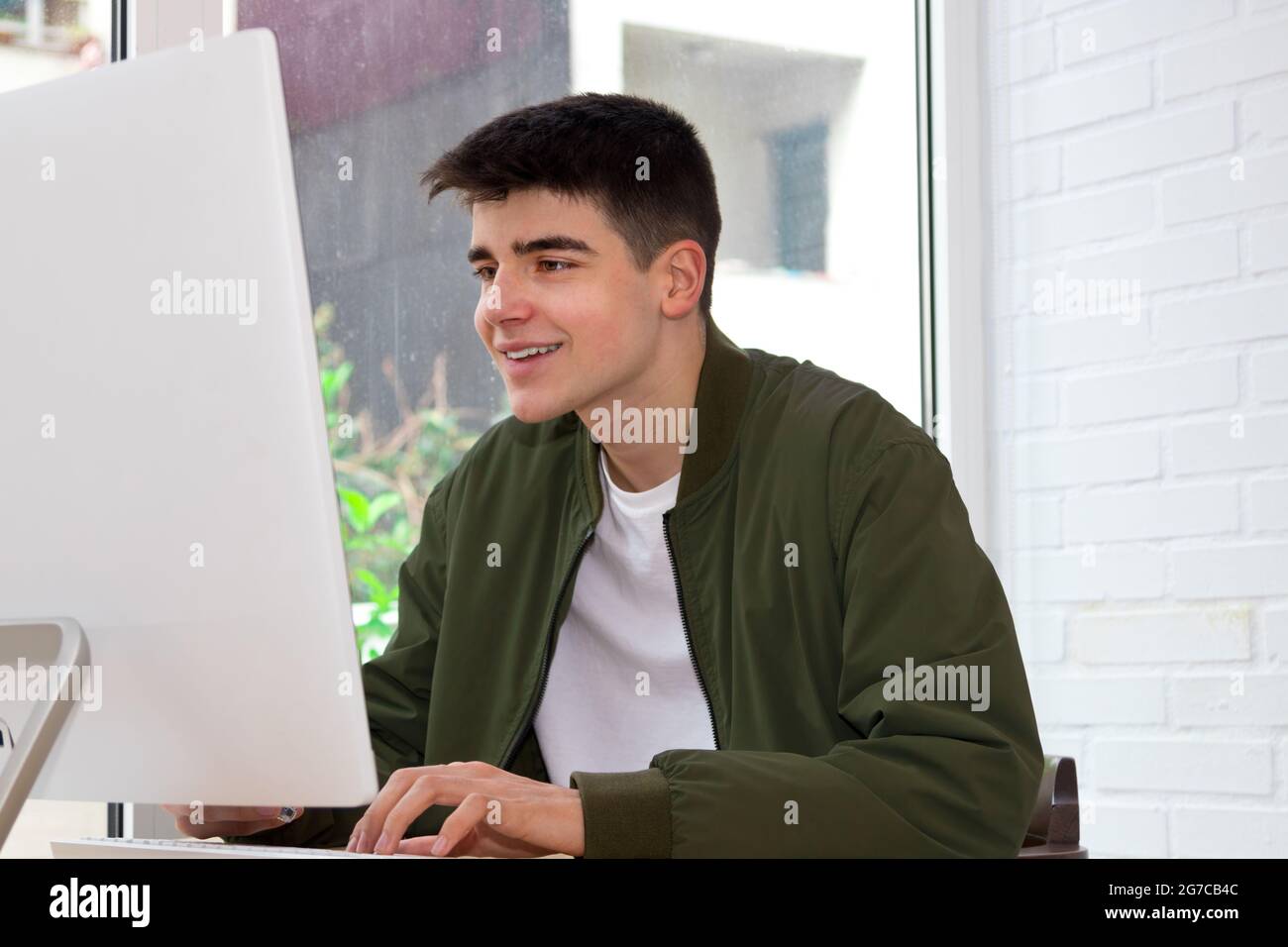young man at home with computer studying Stock Photo - Alamy