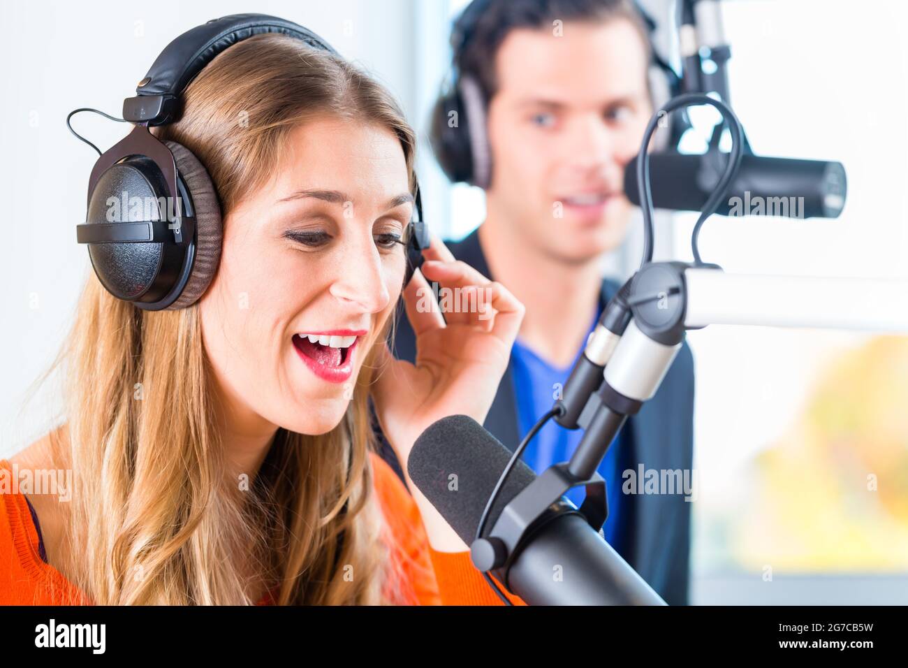 Presenters or moderators - man and woman - in radio station hosting ...