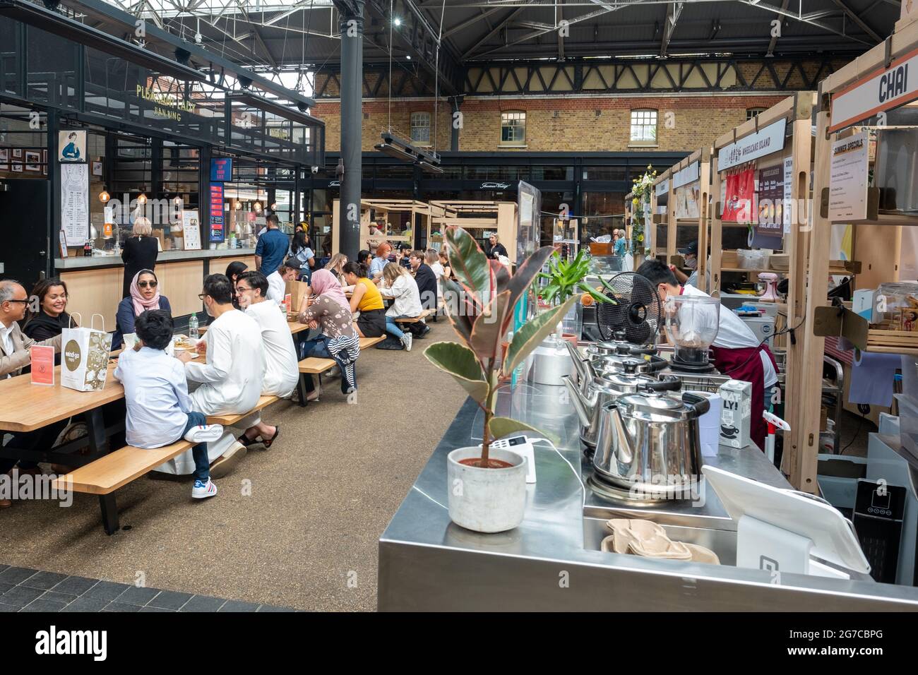 London- July, 2021: Food stalls inside Spitalfields Market. A popular ...