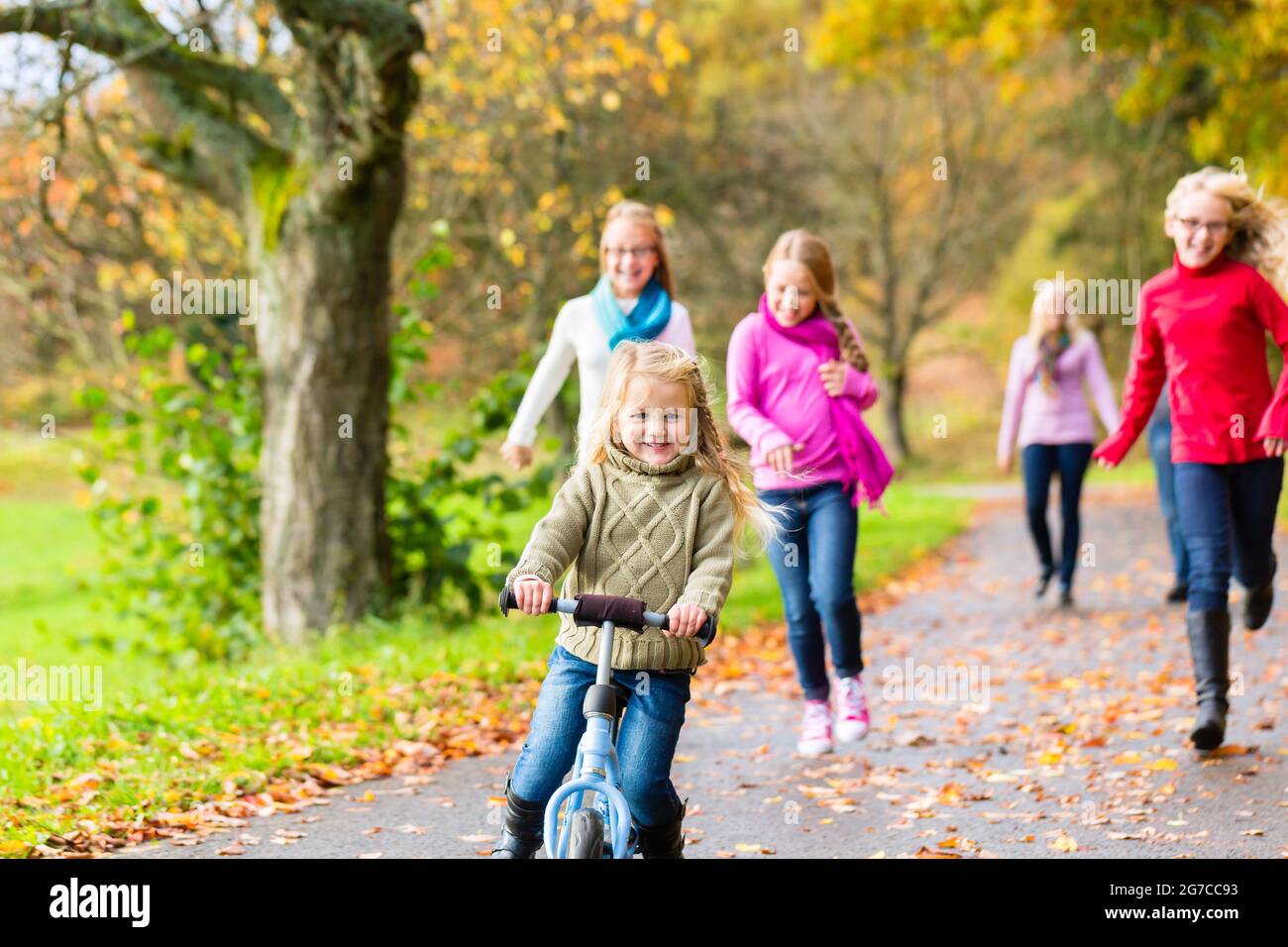 Family taking walk in autumn fall forest Stock Photo - Alamy