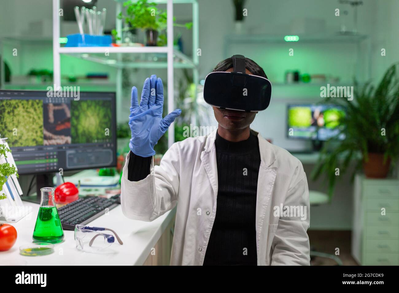 African biologist researcher with virtual reality headset researching ...