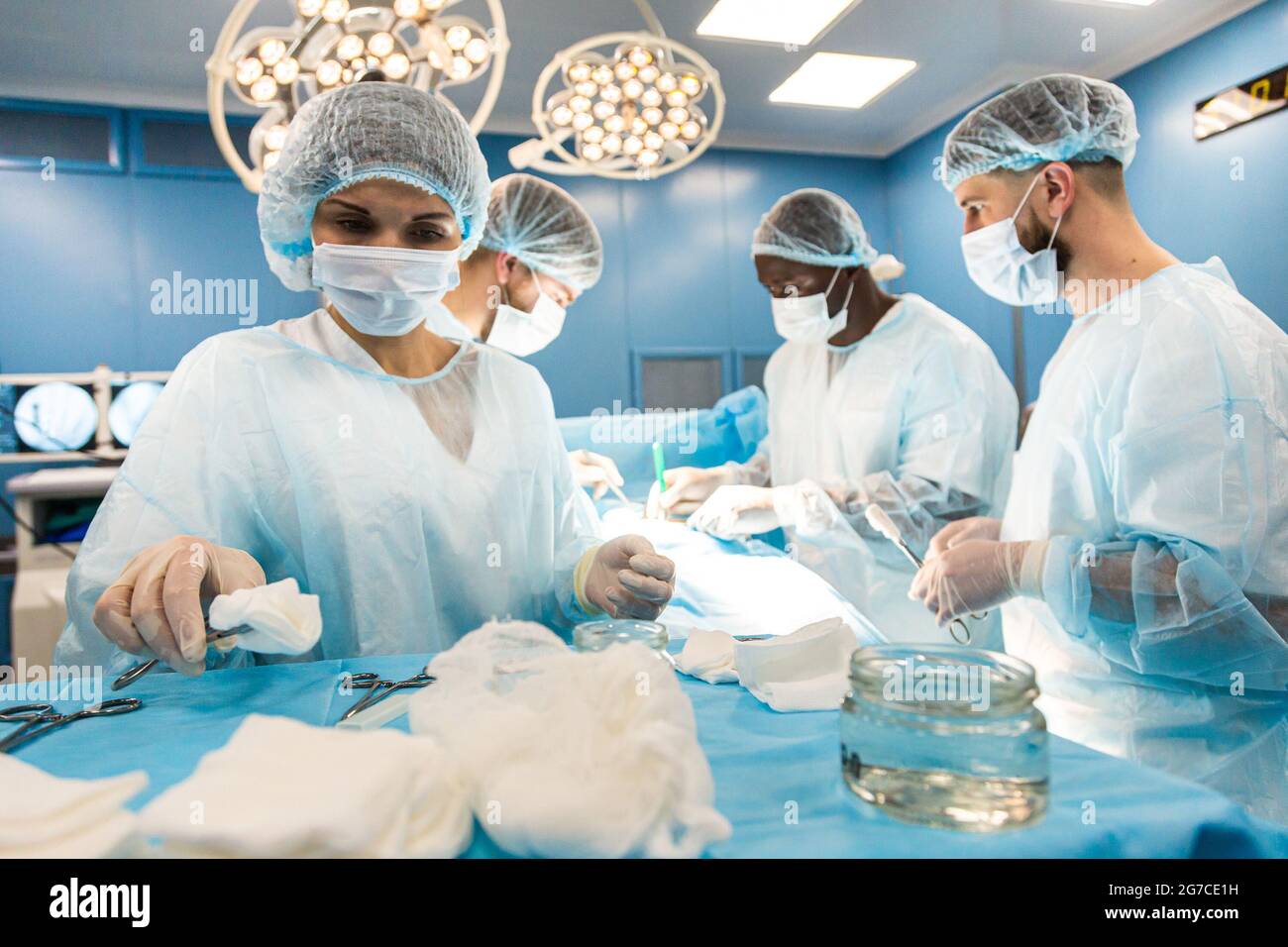 An international team of doctors performs a complex surgical operation ...