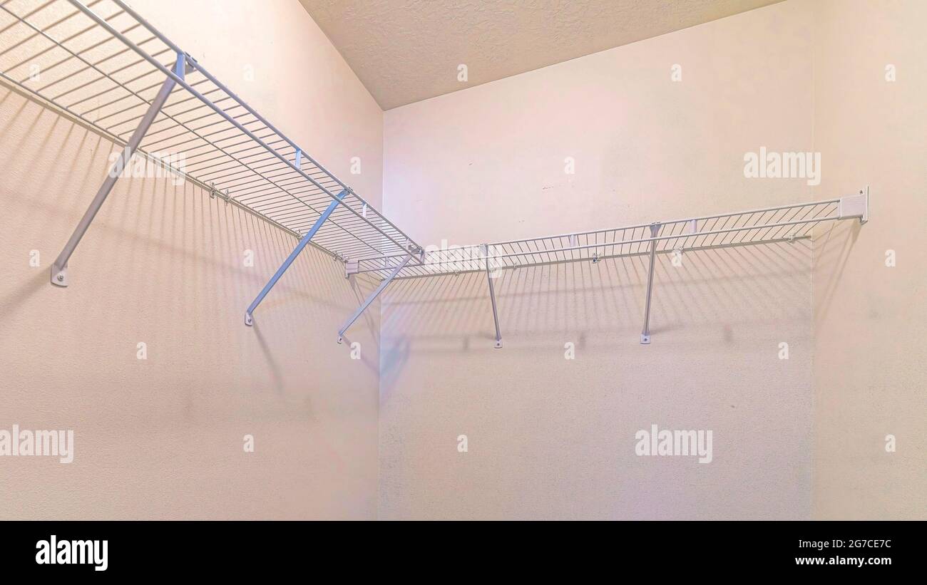 Pano Interior of storage room of a house with wire shelves mounted on ...