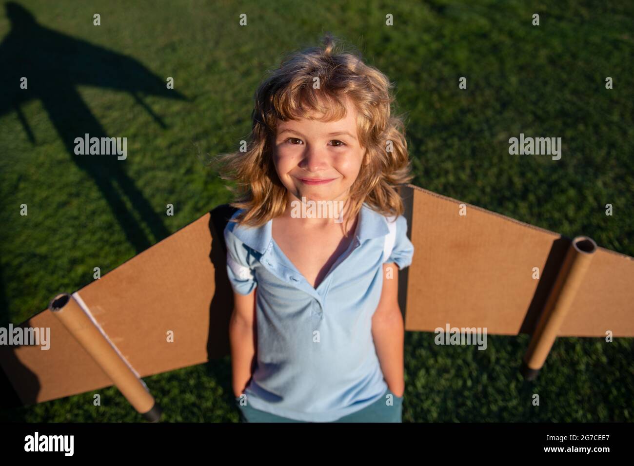 Portrait of kid with backpack wings. Child playing pilot aviator and ...