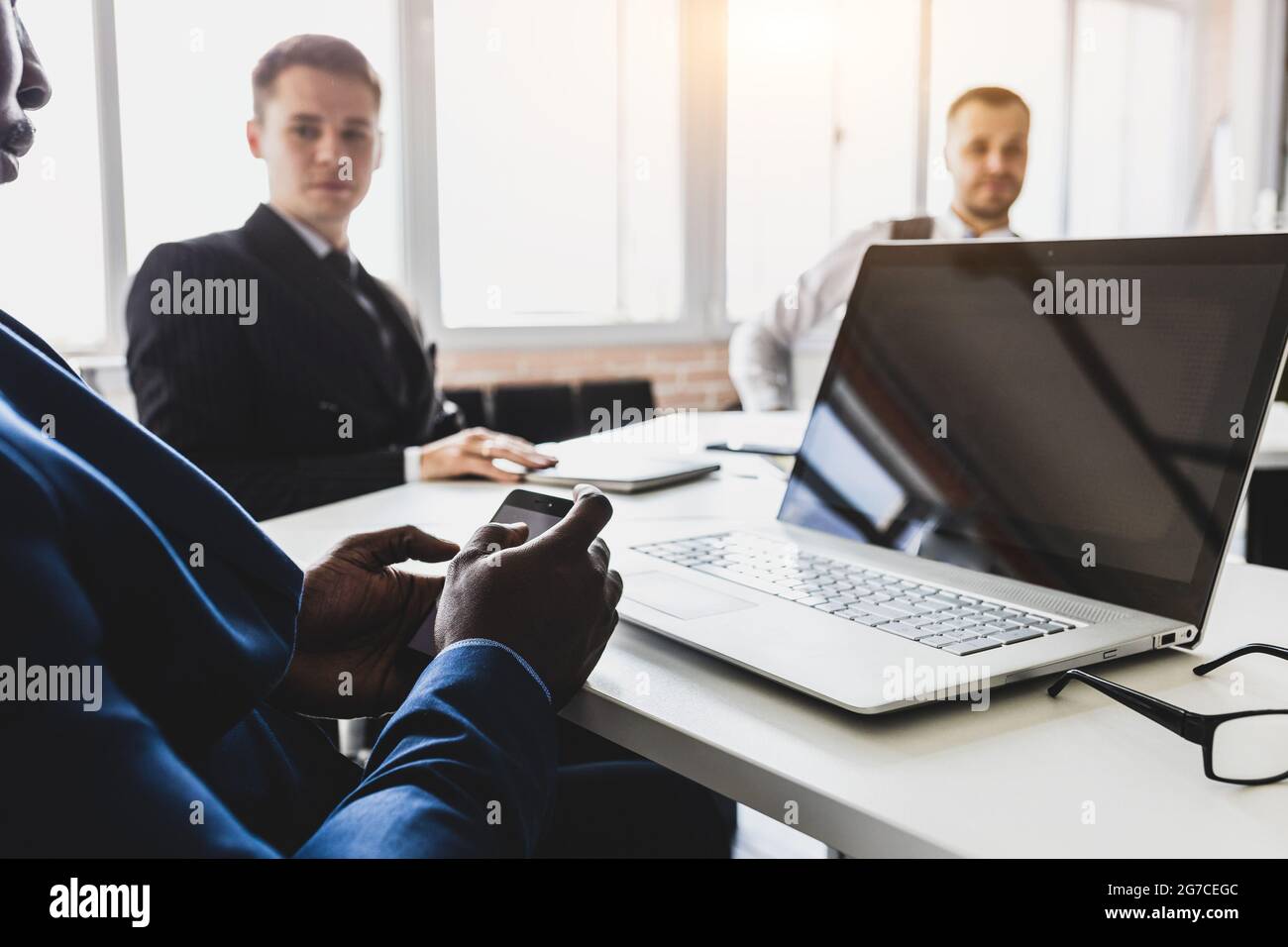 Group of young business people in smart casual wear working together in ...