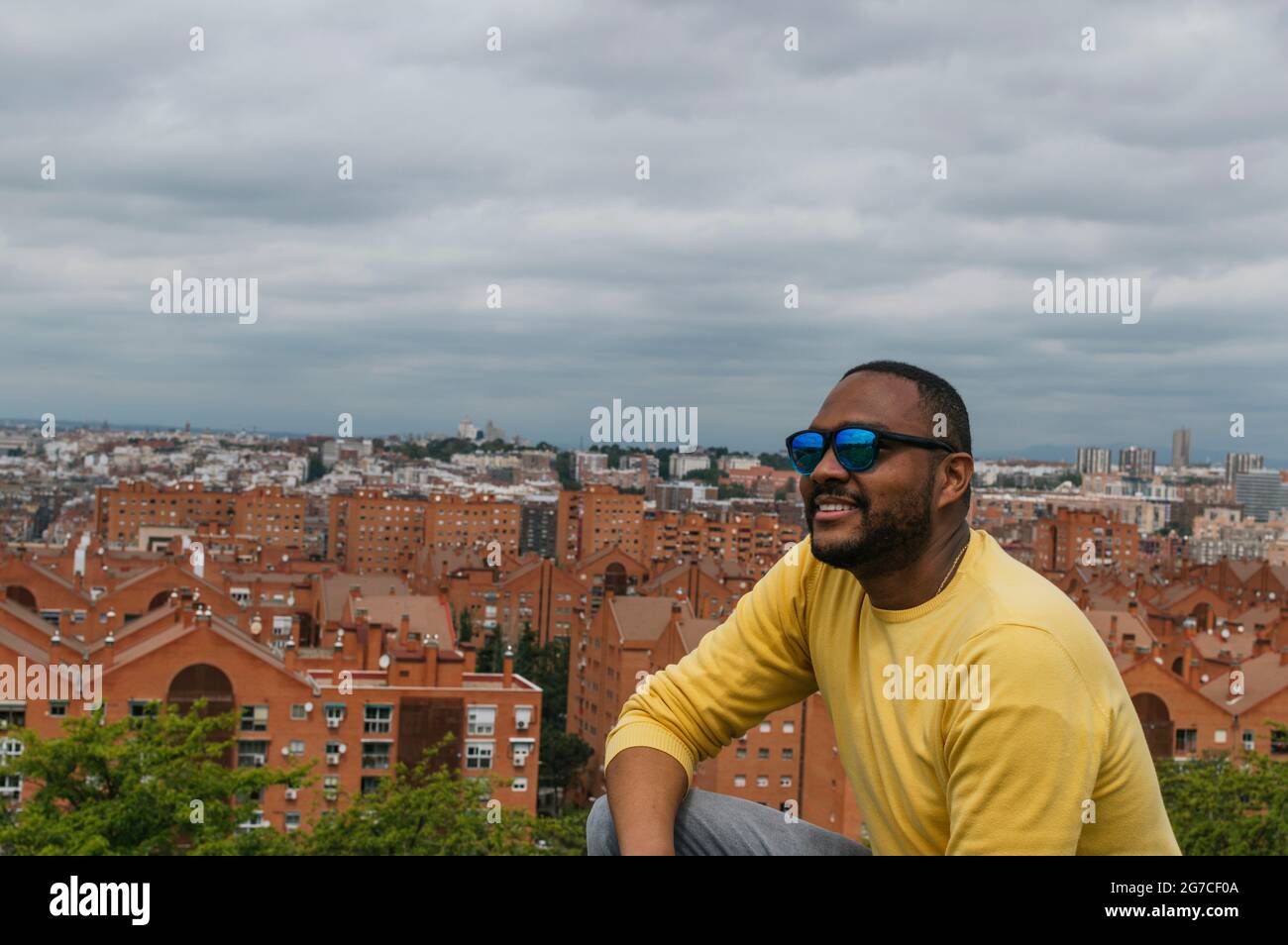 Black man looking at the horizon in a park with glasses Stock Photo - Alamy