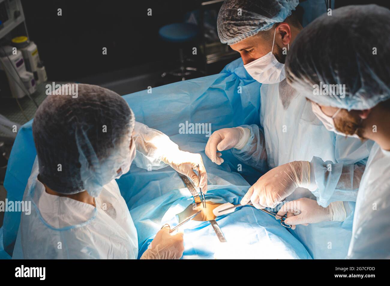 An international team of doctors performs a complex surgical operation ...