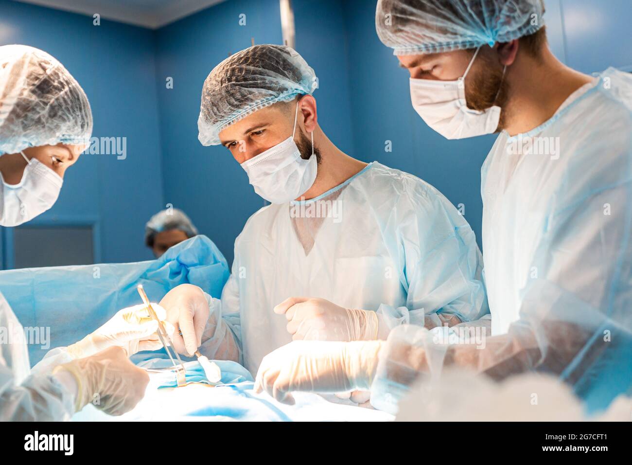 An international team of doctors performs a complex surgical operation ...