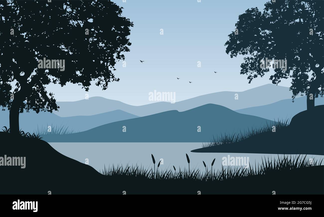 Stunning Mountain views from the riverbank in the misty morning with ...