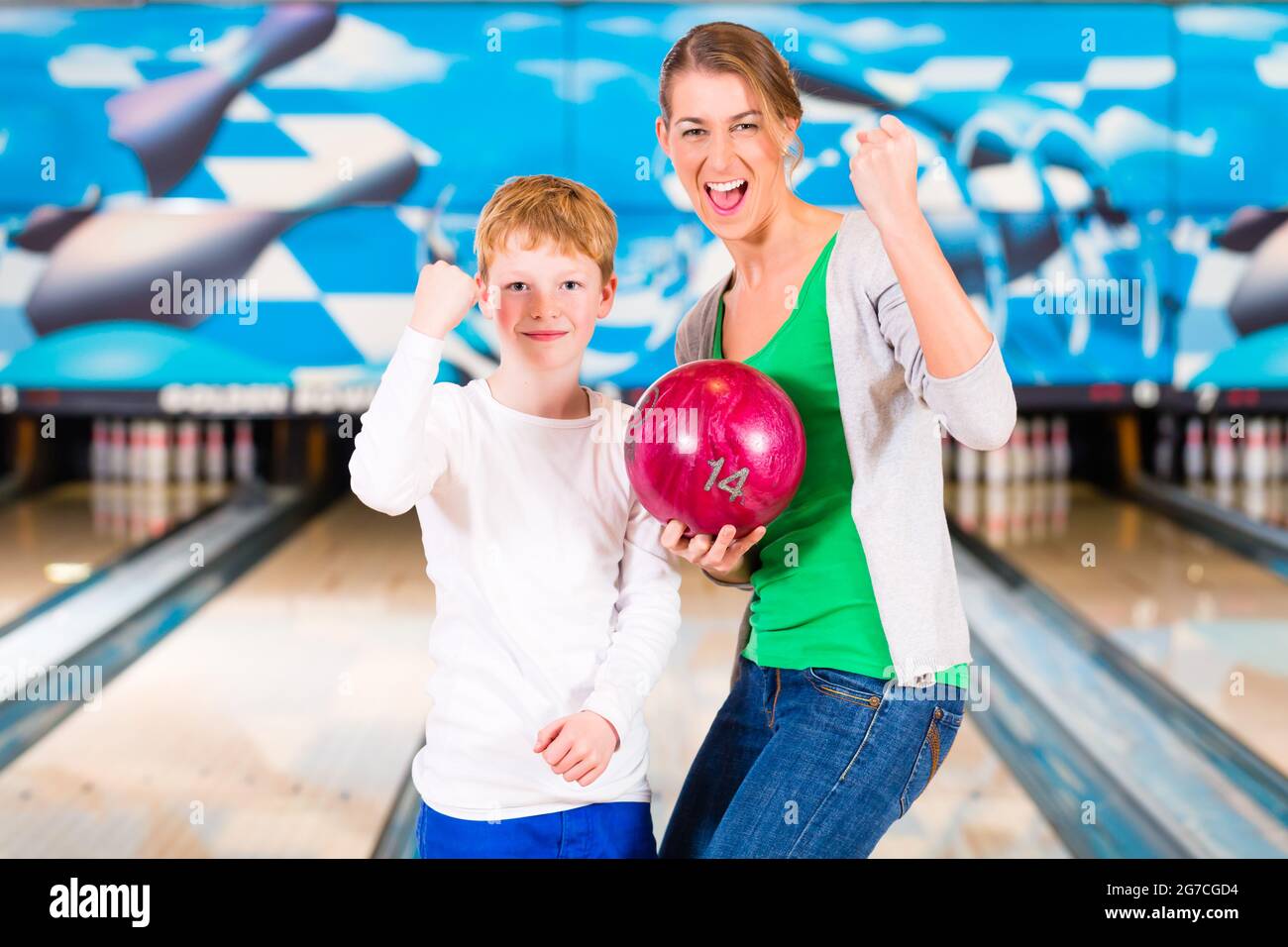 Mother and son playing together at bowling center Stock Photo - Alamy