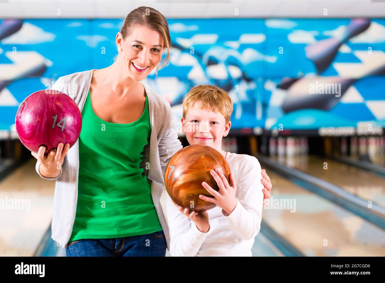 Mother and son playing together at bowling center Stock Photo - Alamy