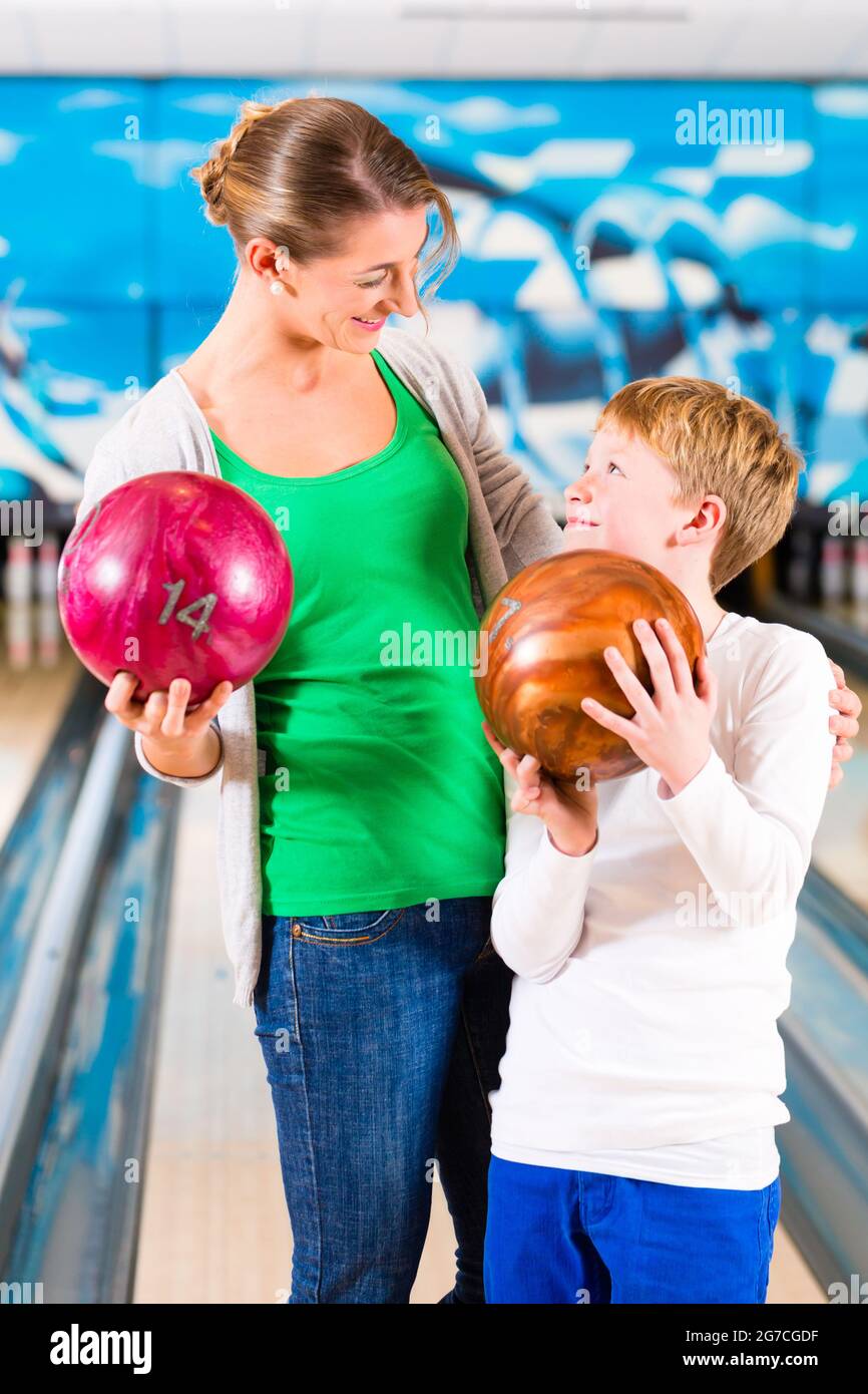 Mother and son playing together at bowling center Stock Photo - Alamy