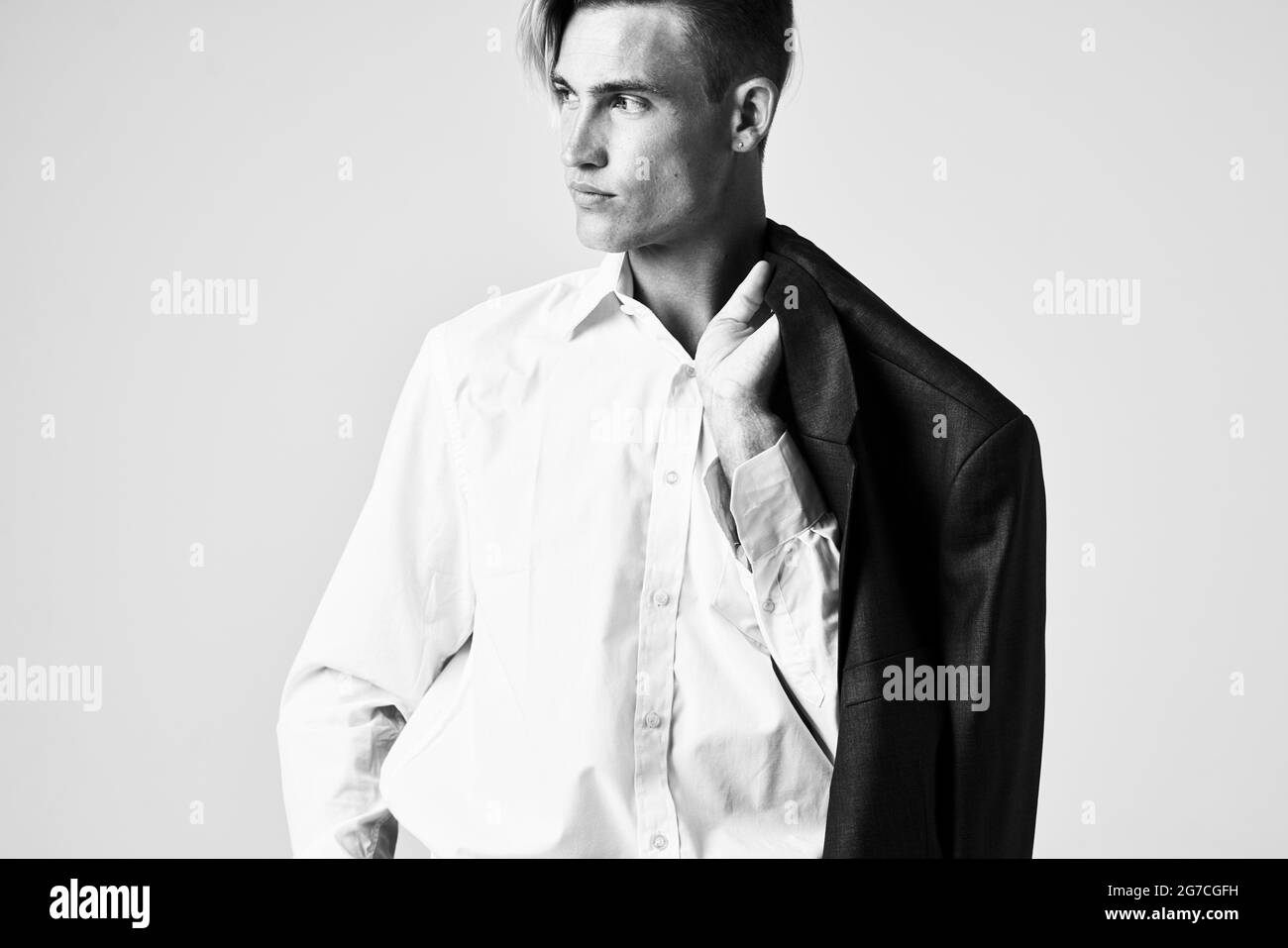 man with a jacket over his shoulders fashion studio lifestyle model ...