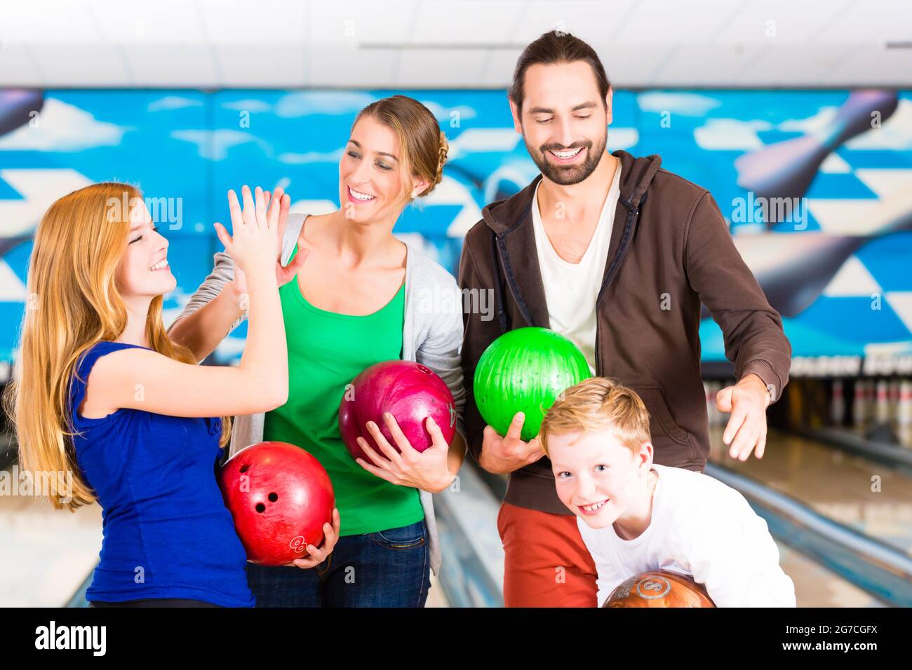 Family at Bowling Center Stock Photo - Alamy