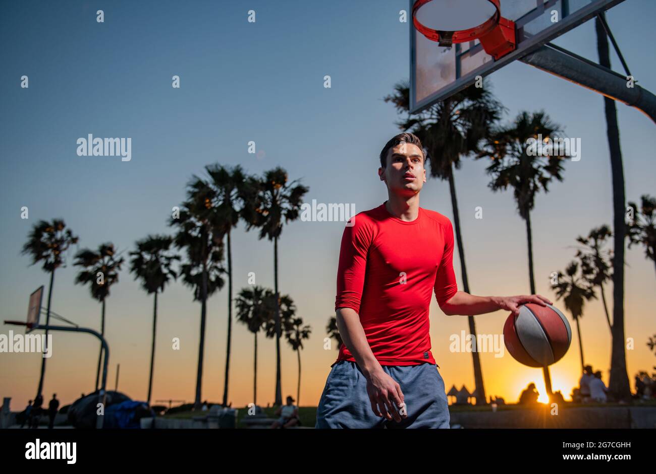 Basketball player. Sports and basketball. Sunset sky and court in the ...