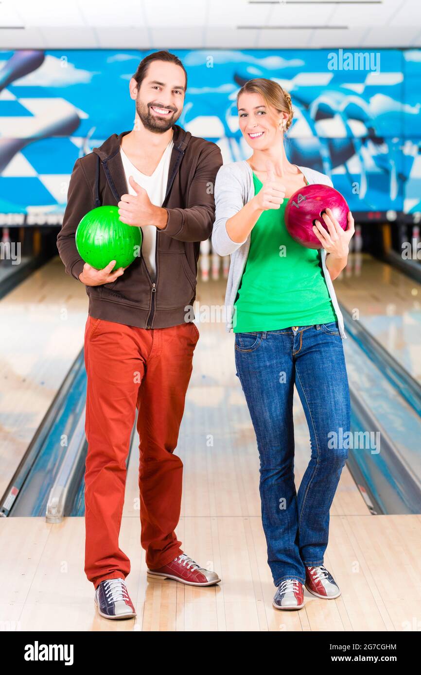 Friends playing Bowling at bowling Stock Photo - Alamy