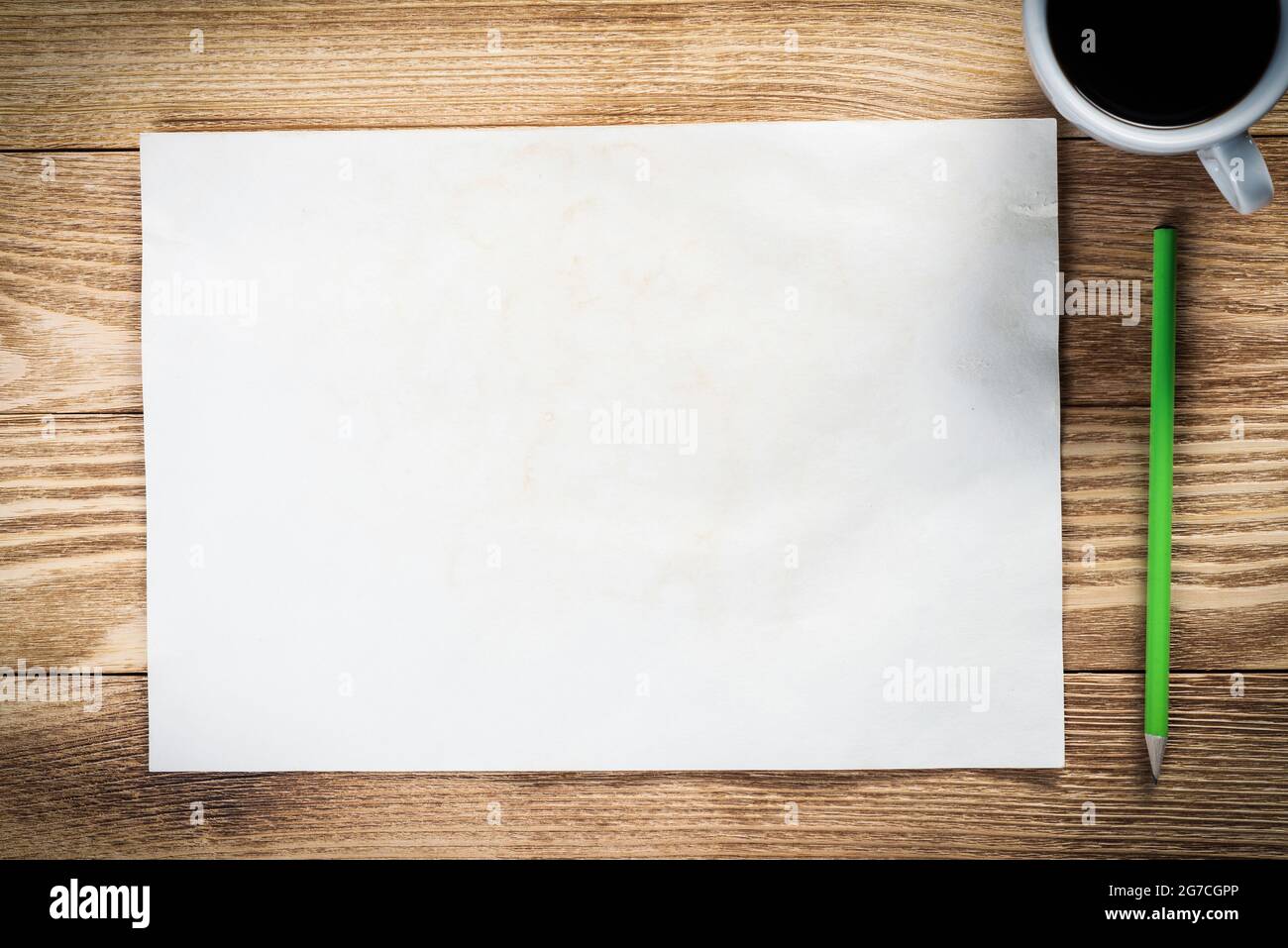 Sheet of paper lying on wooden table Stock Photo - Alamy